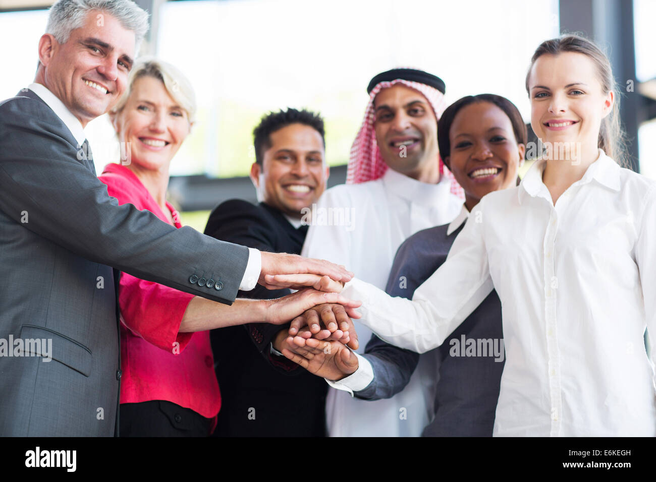 close up of multiracial business team putting their hands together ...