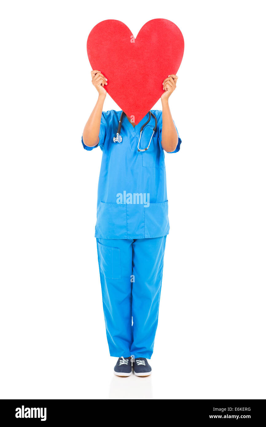 African nurse hiding her face behind heart shape isolated on white ...