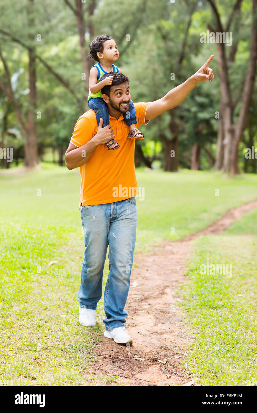 caring young Indian father and son walking outdoors in forest Stock ...