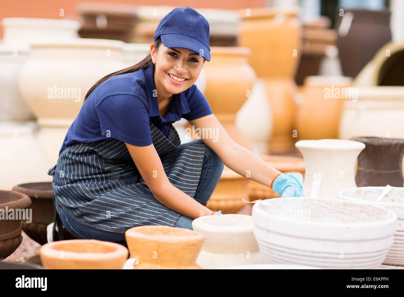 pretty young hardware store worker working in home and garden center ...