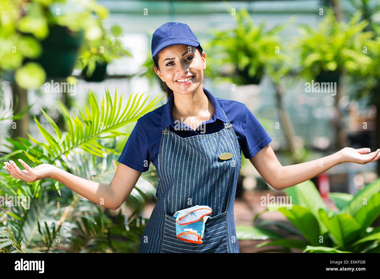 pretty female gardener with arms open in greenhouse Stock Photo - Alamy