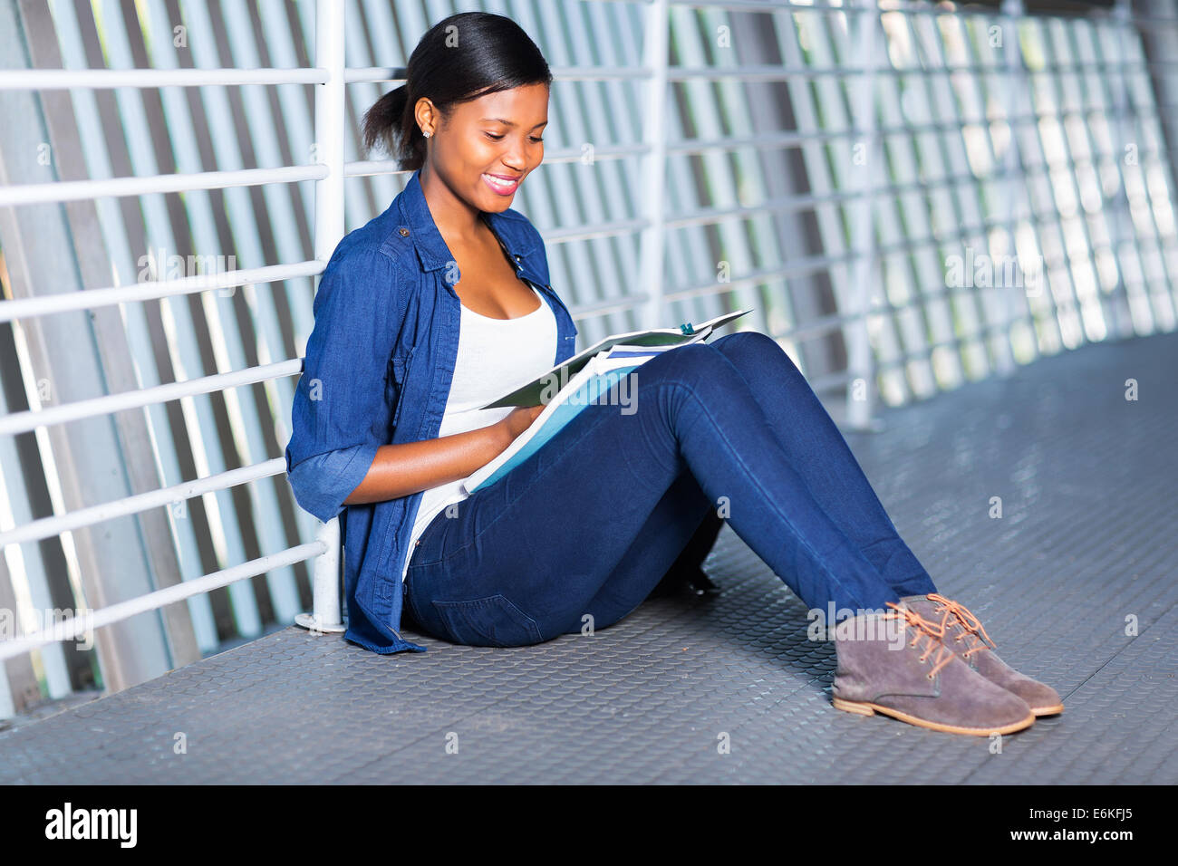 pretty young African uni student reading a book Stock Photo - Alamy
