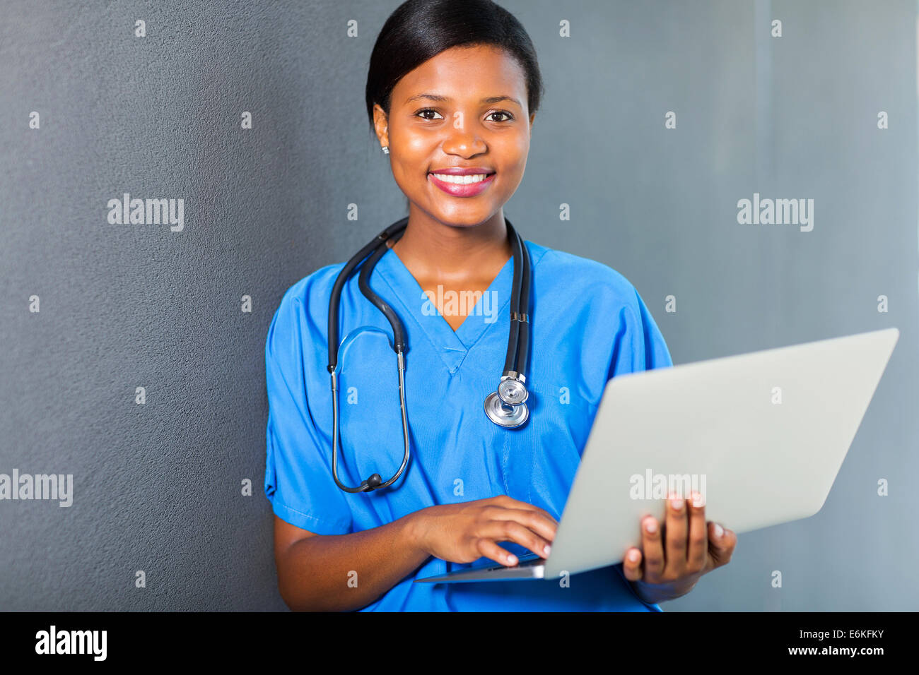 attractive African American female nurse using laptop Stock Photo - Alamy