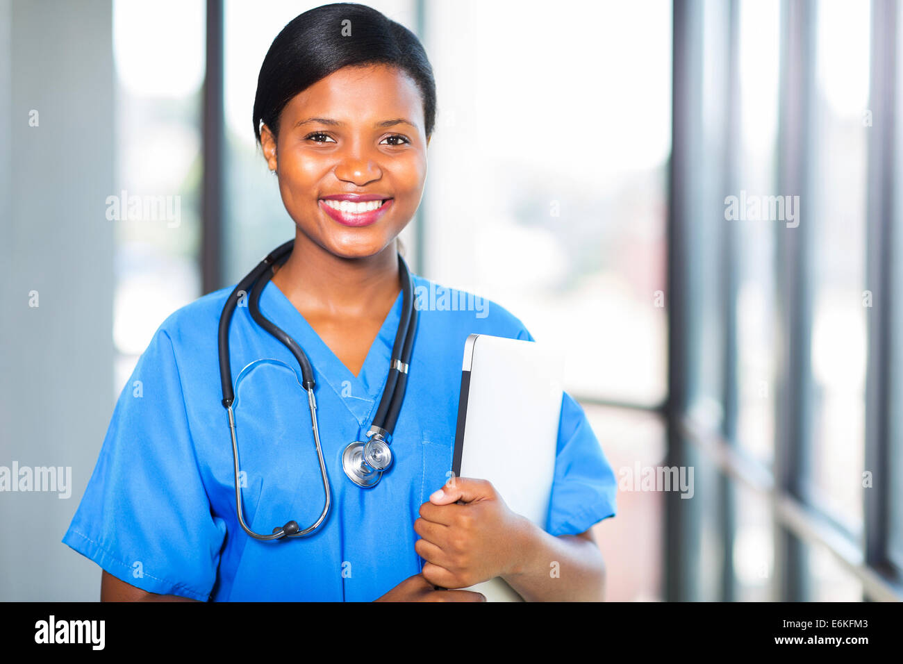 happy young African medical intern doctor holding laptop Stock Photo ...