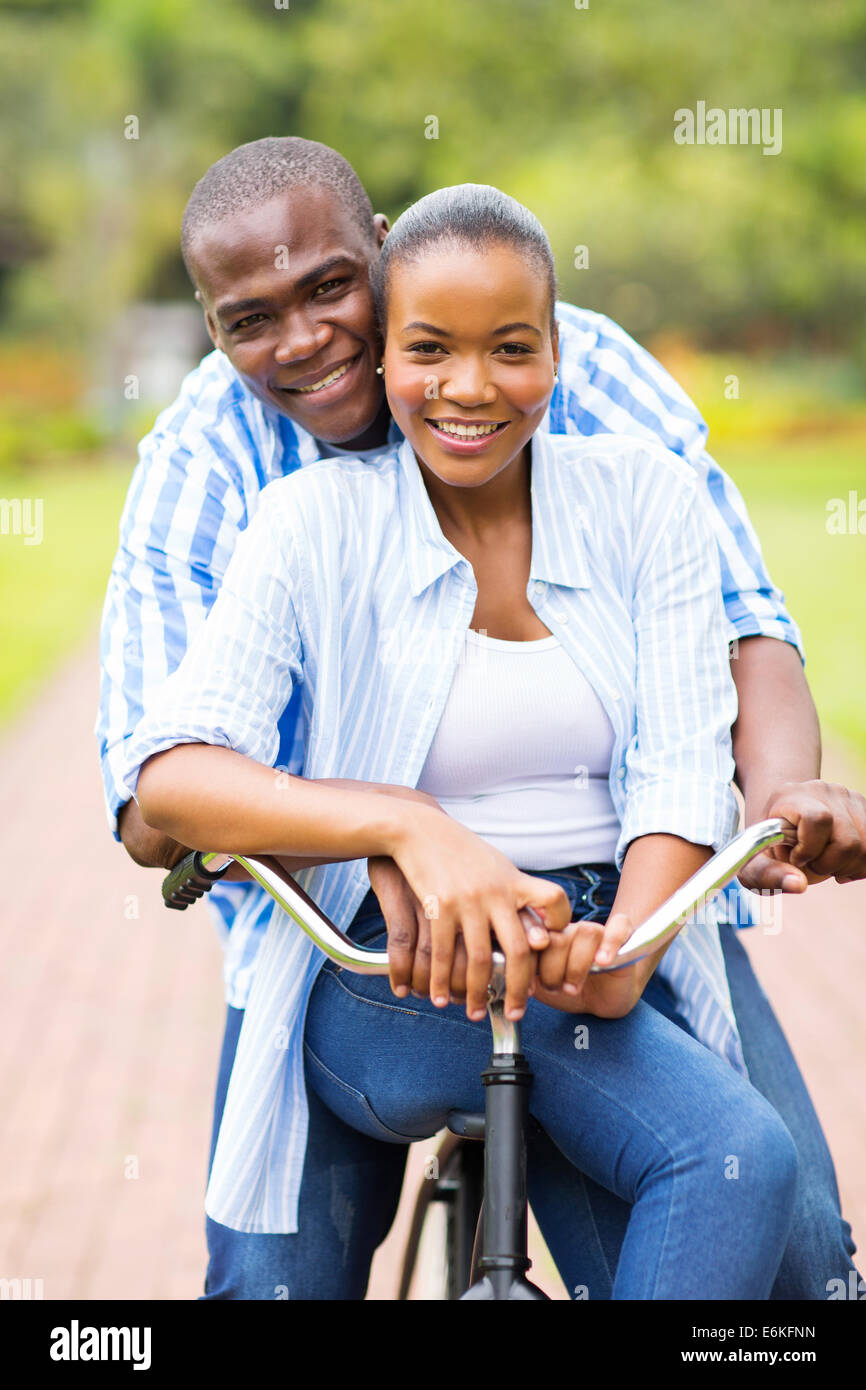 young African couple riding bicycle Stock Photo - Alamy