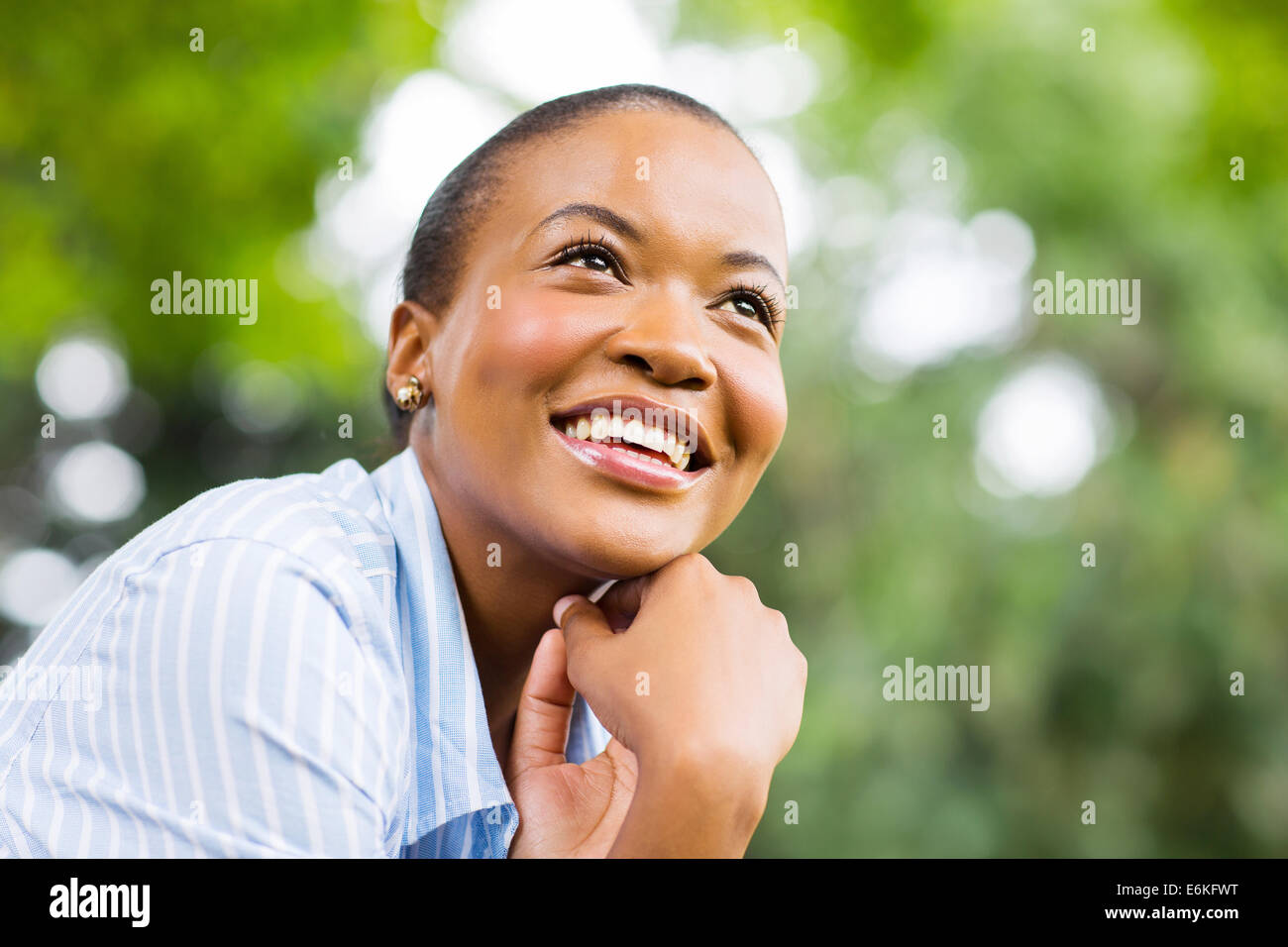 pretty young African woman looking up Stock Photo - Alamy