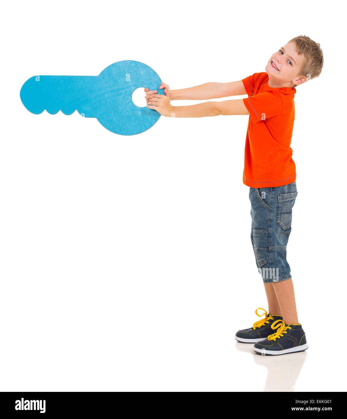 happy little boy opening with a huge key isolated on white Stock Photo ...