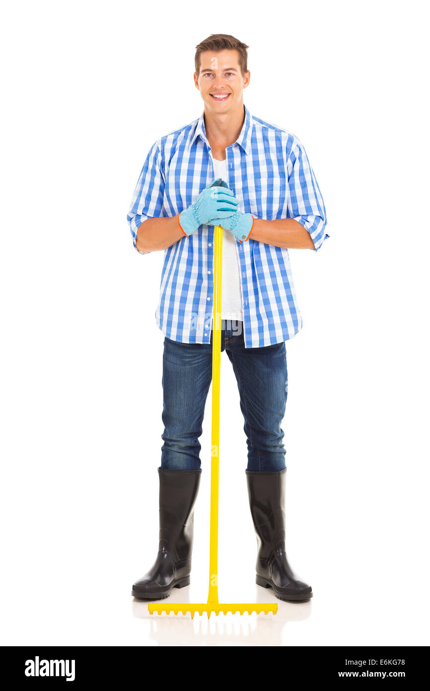 young man standing with metal garden rake isolated on white Stock Photo ...