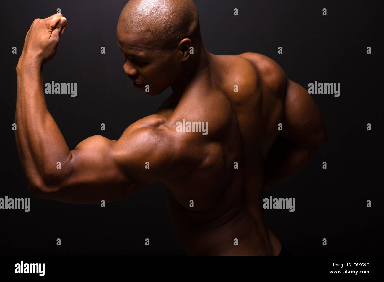 strong African American bodybuilder posing on black background Stock ...