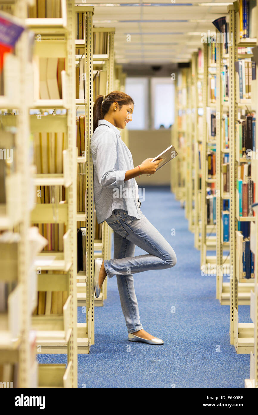 young Indian college girl reading a book in library Stock Photo - Alamy