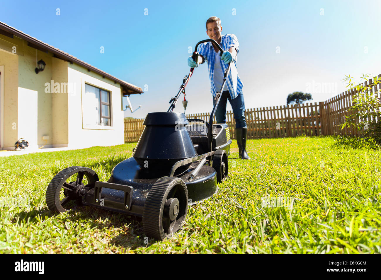 Young man lawn mower hi-res stock photography and images - Alamy