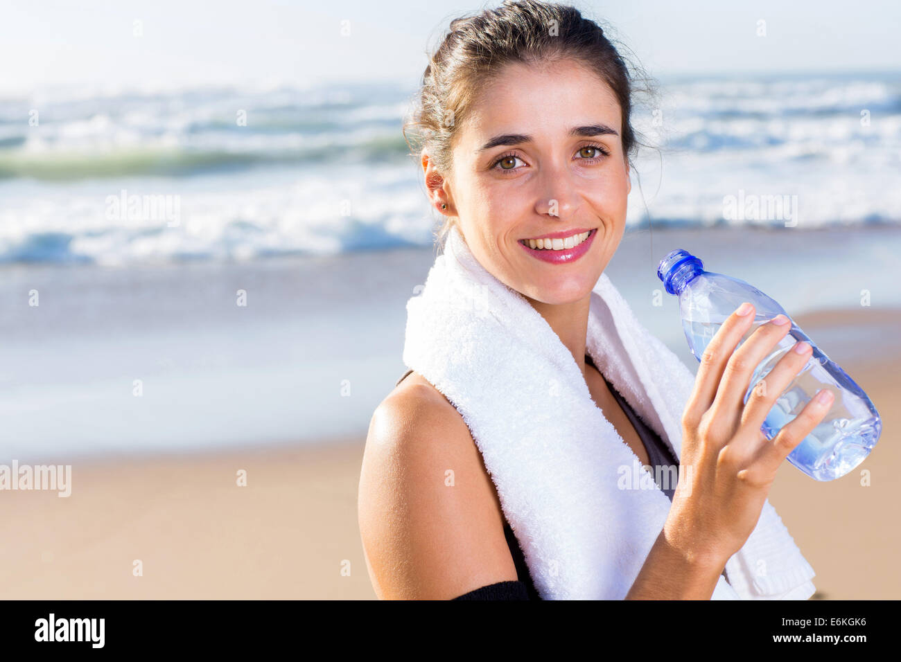 pretty healthy woman drinking water after exercise on beach Stock Photo ...