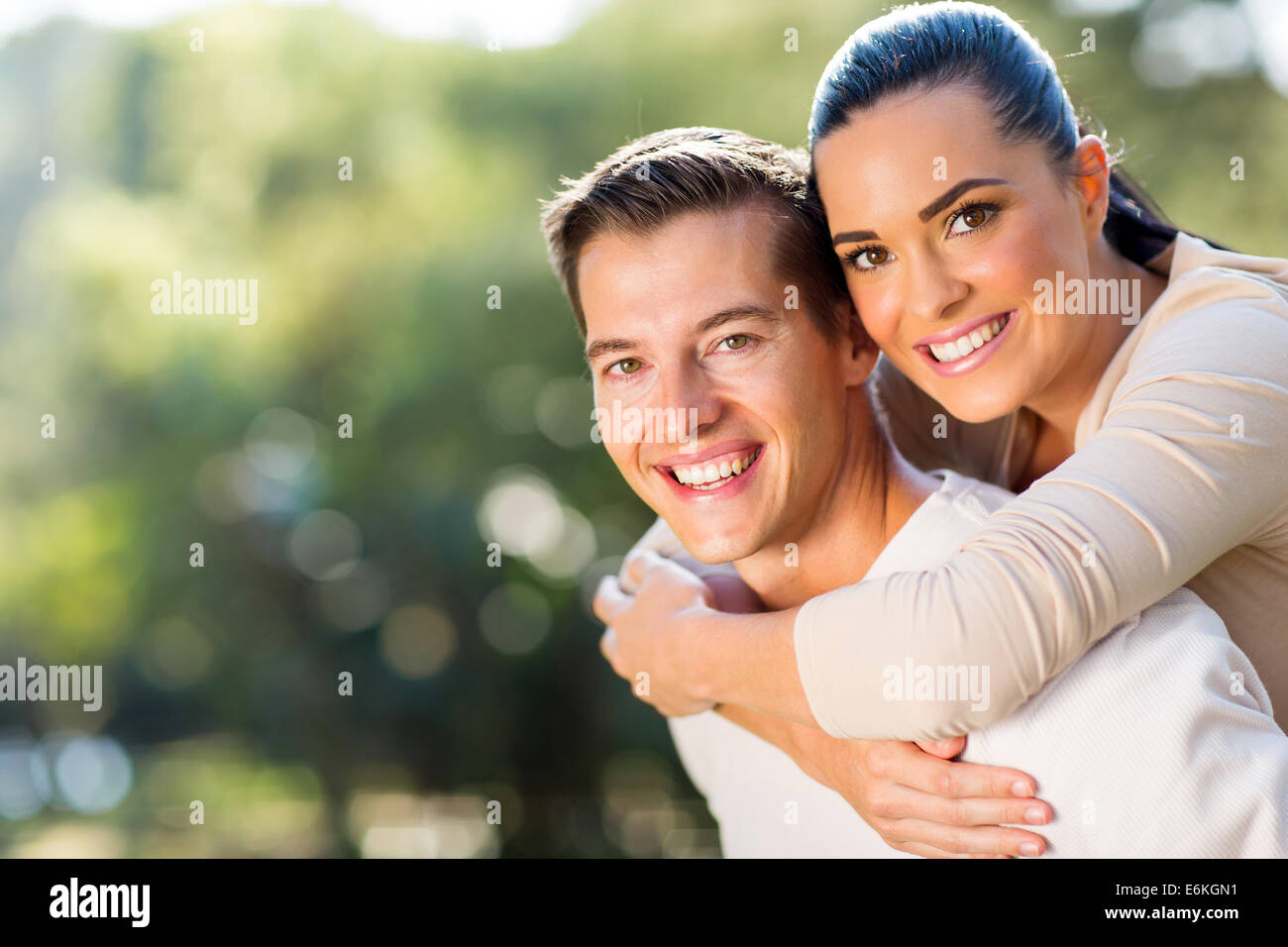 happy woman enjoying piggyback ride on boyfriends back outdoors Stock ...