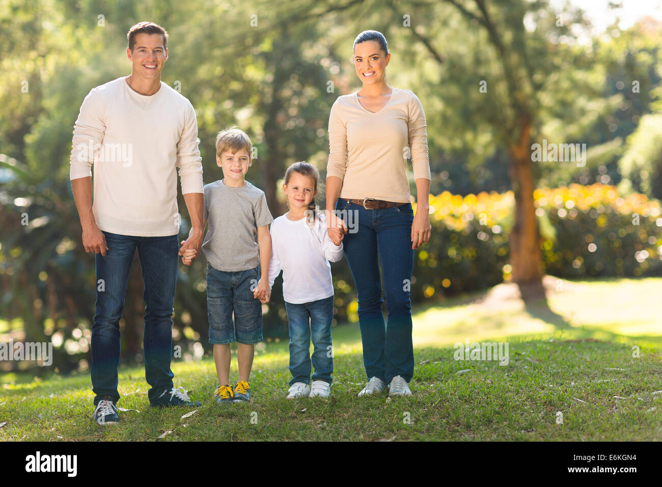 portrait of young family standing together outdoors Stock Photo - Alamy