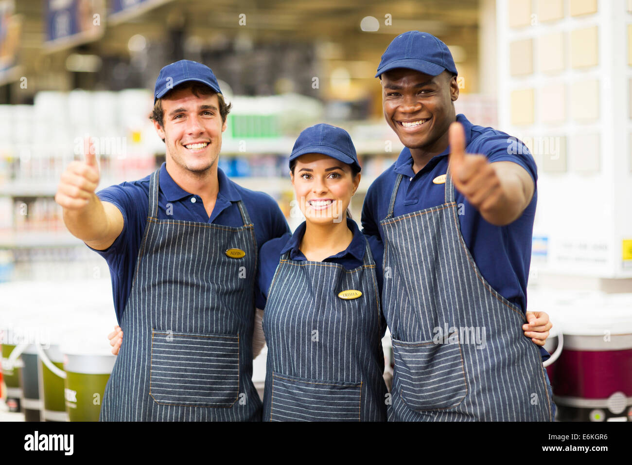 group hardware store workers giving thumbs up Stock Photo - Alamy
