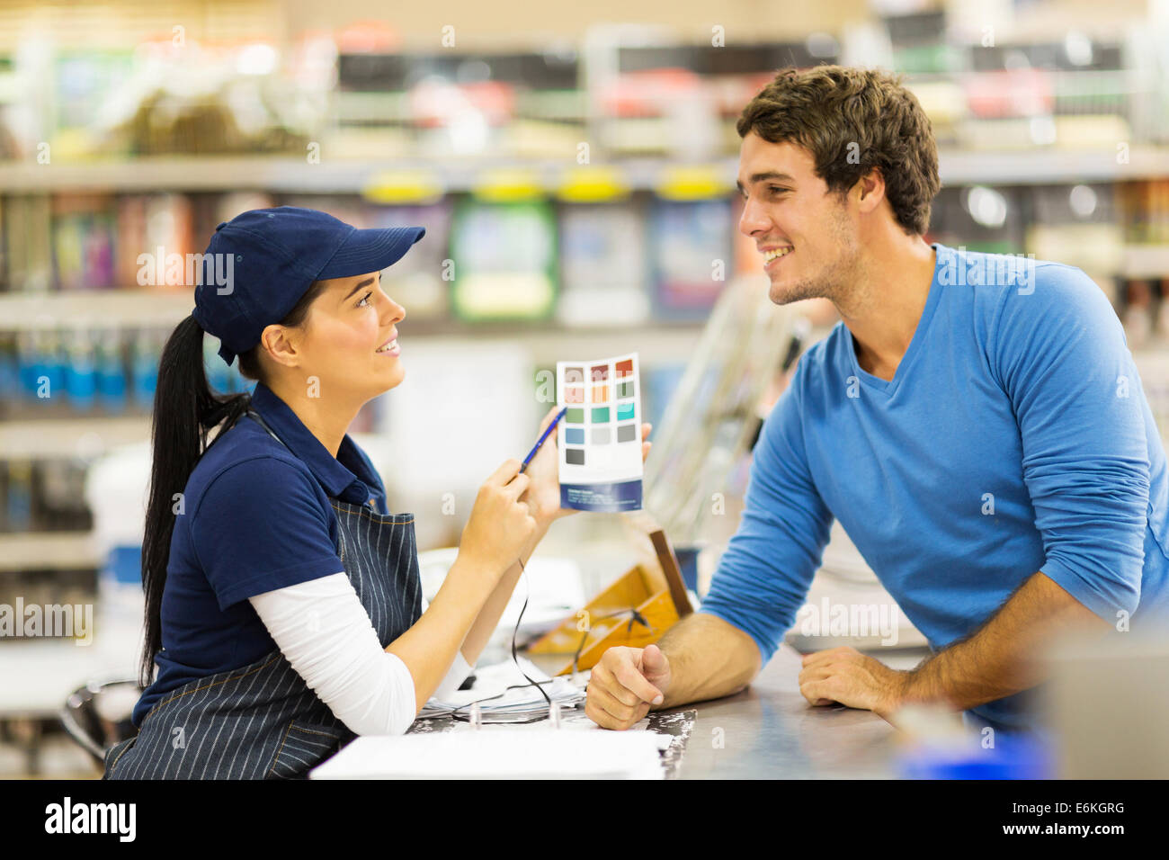 pretty paint store assistant helping customer choose paint color Stock ...