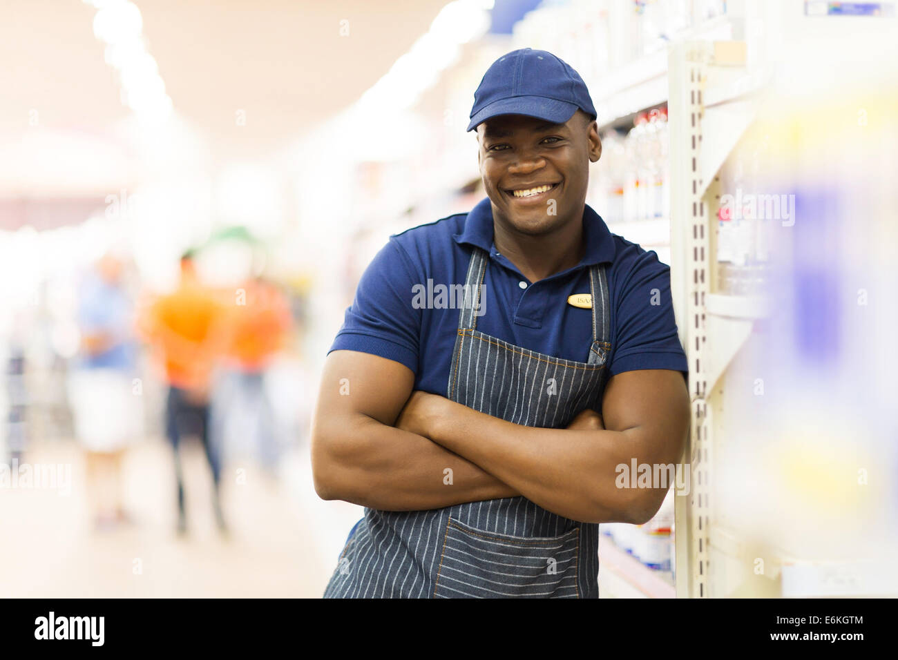 Male African American store clerk weighing bell peppers on scale Stock ...