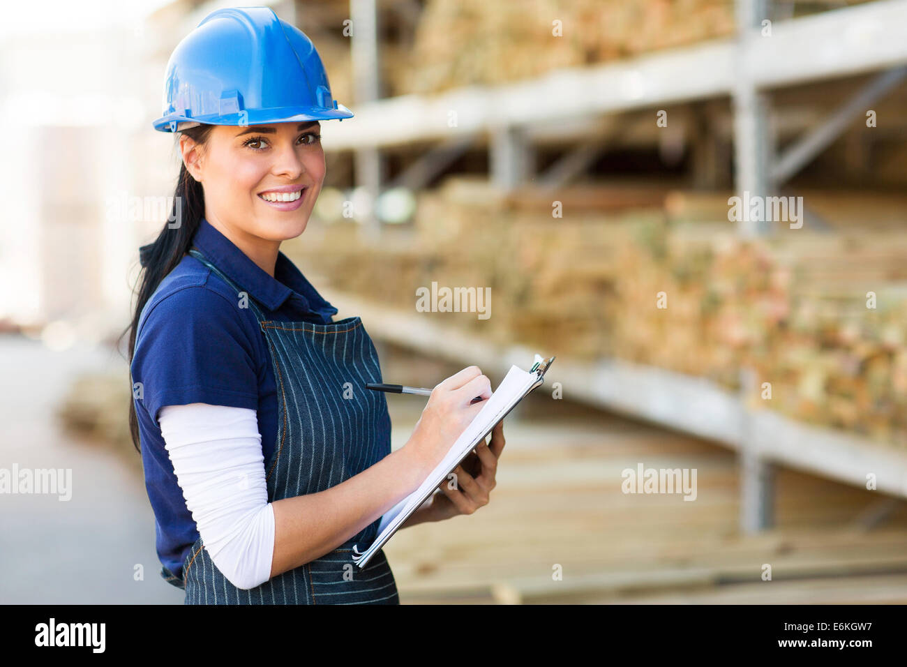 pretty female hardware store worker working in warehouse Stock Photo ...