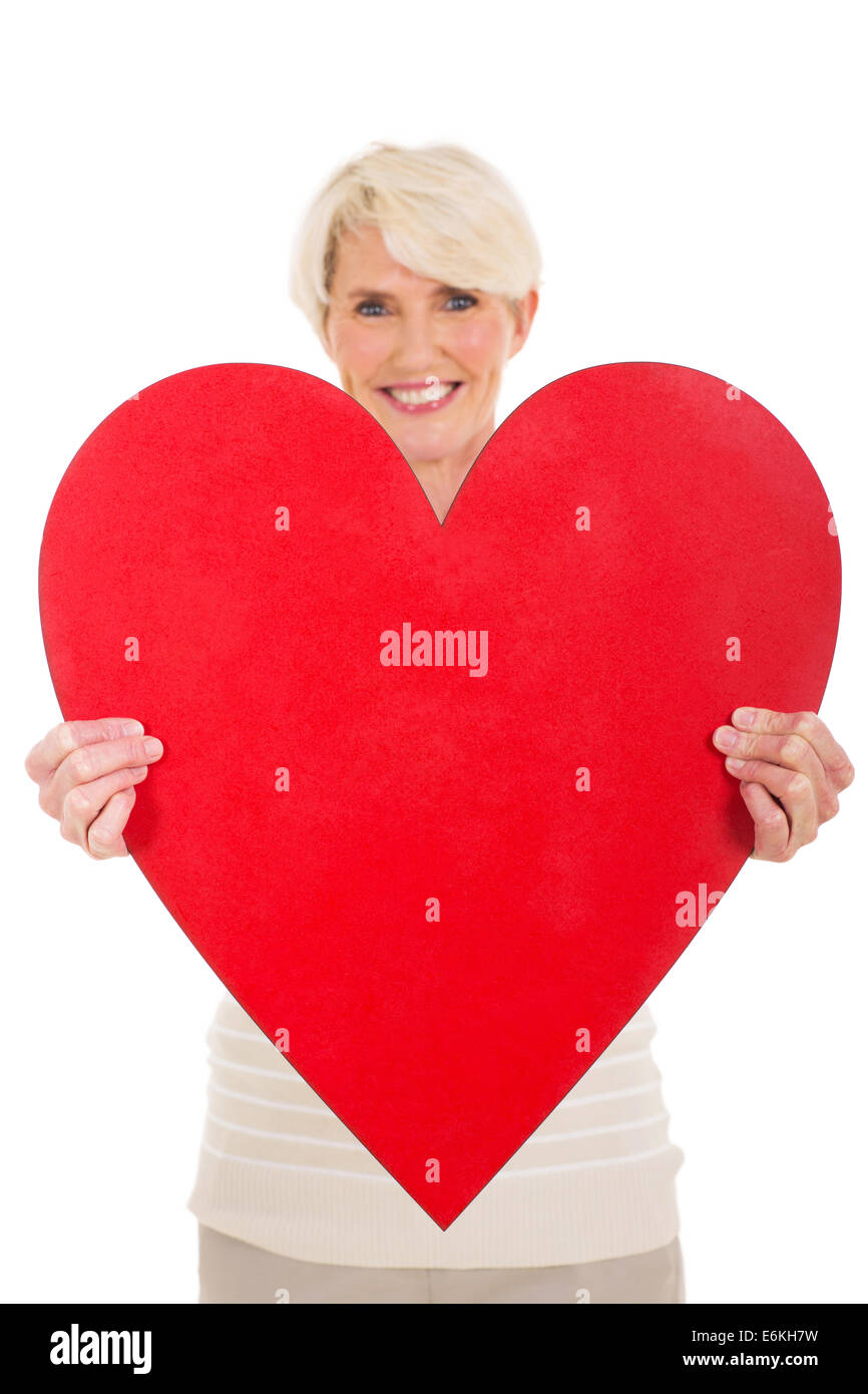 pretty middle aged woman presenting heart shape on white background ...