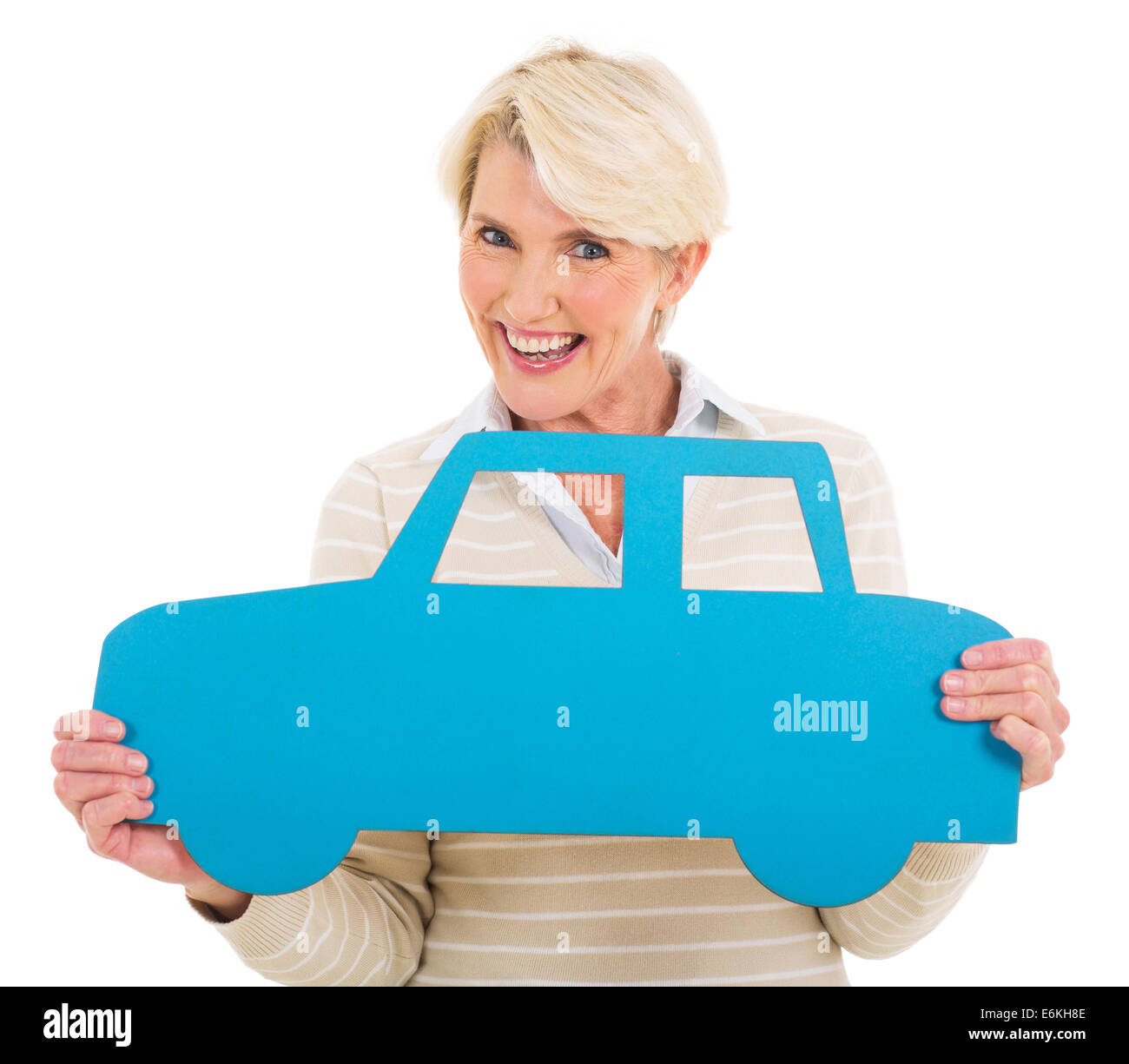 cheerful middle aged woman holding a car symbol on white background ...