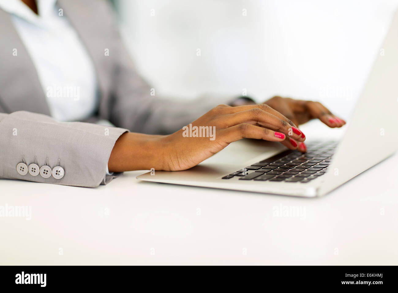 close up of African businesswoman hands working on laptop Stock Photo ...