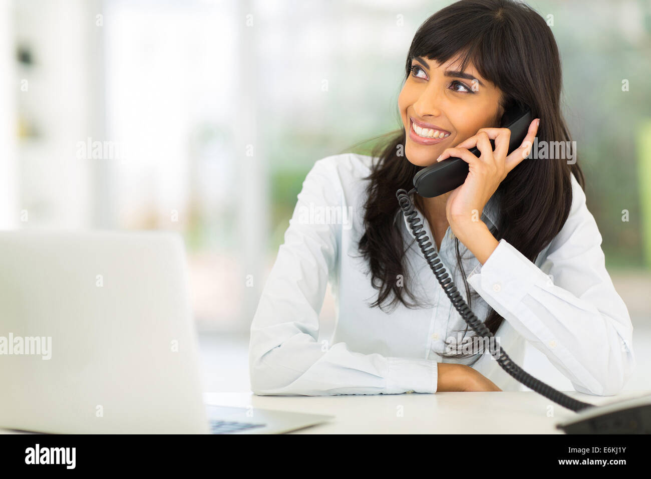 attractive Indian office worker talking on the phone Stock Photo - Alamy