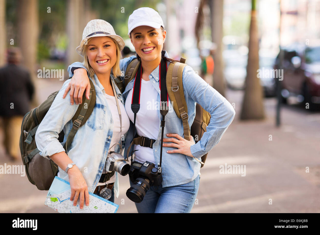 happy two female friends touring together in the city Stock Photo - Alamy