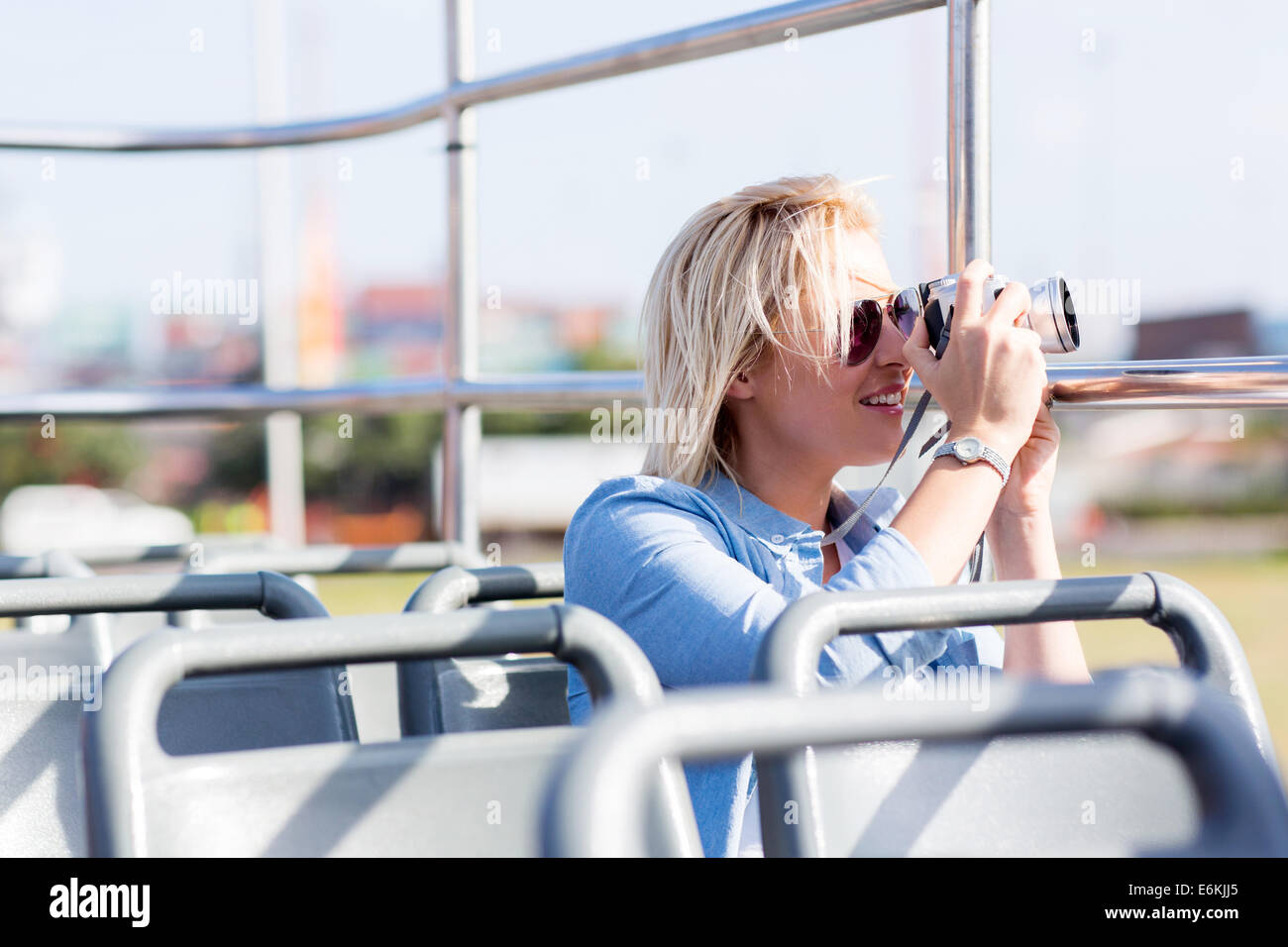 beautiful tourist taking photos of the city from an open top bus Stock ...