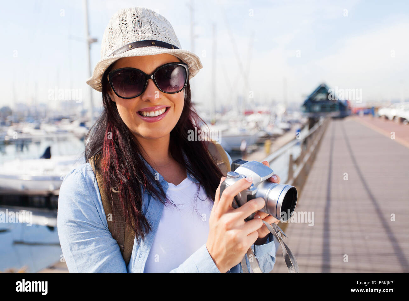 attractive tourist with camera by the harbour Stock Photo - Alamy