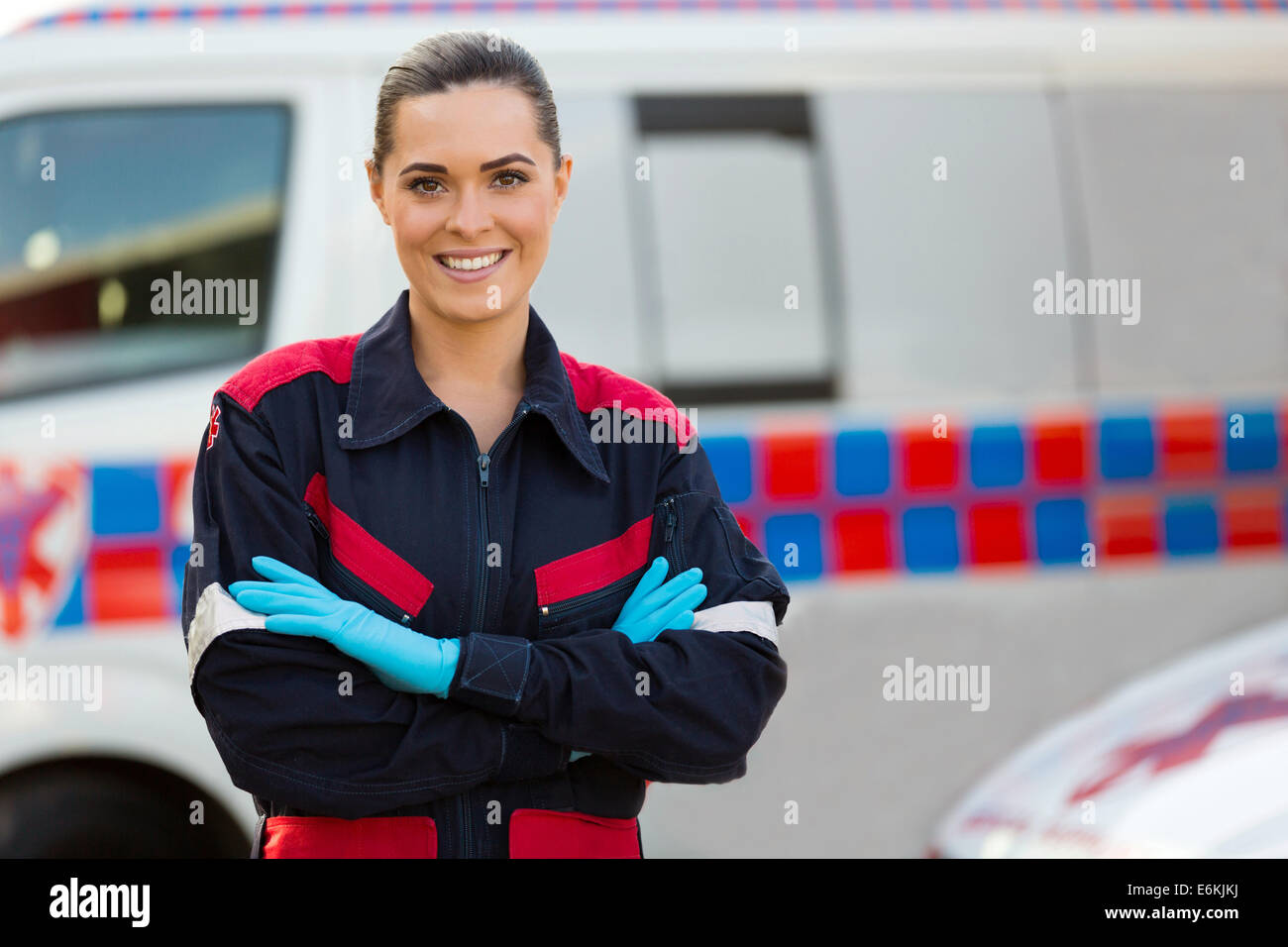 beautiful female paramedic with arms crossed in front of ambulance ...