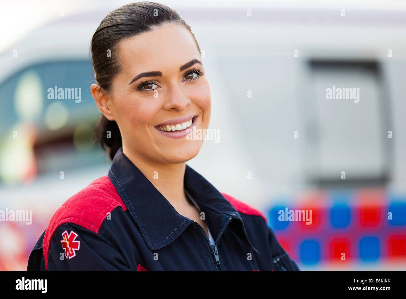 pretty young female paramedic looking at the camera Stock Photo - Alamy