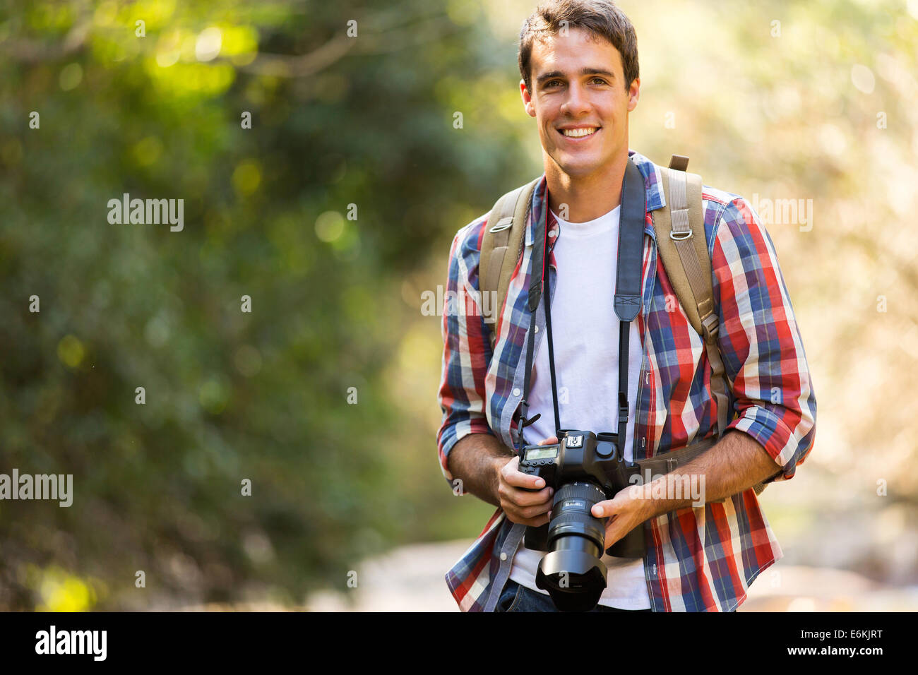 handsome young man hiking in mountain valley with dslr camera Stock ...