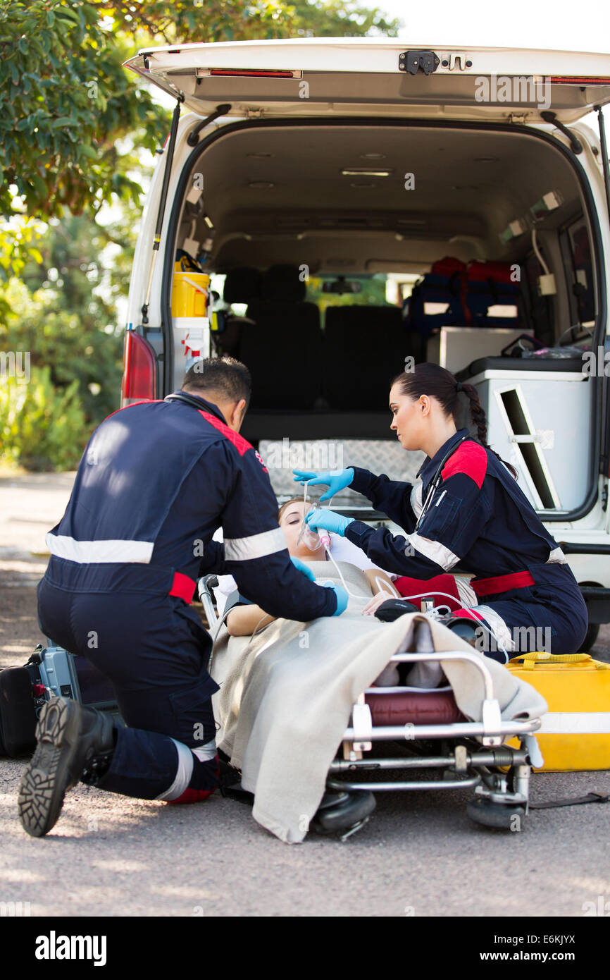 Paramedic putting oxygen mask on unconscious patient Stock Photo - Alamy