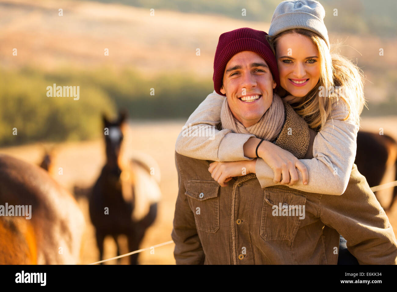 happy woman enjoying piggyback ride on boyfriends back Stock Photo - Alamy