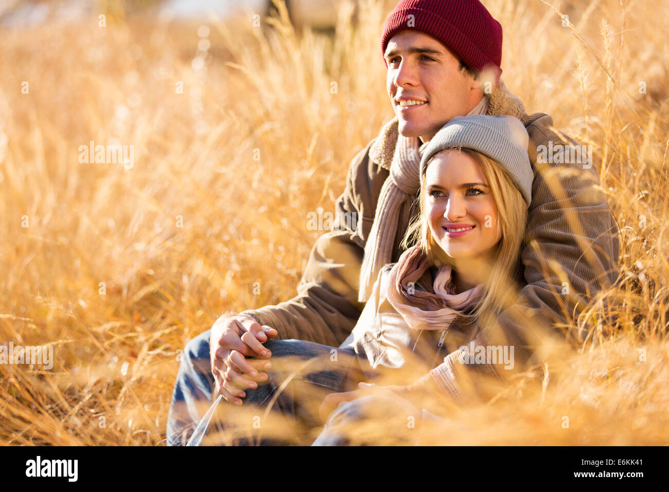 romantic young couple sitting outdoors in fall Stock Photo - Alamy