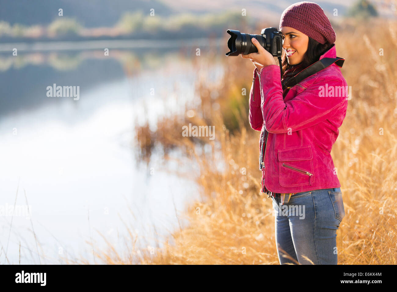 beautiful photographer take photo outdoors by the lake in autumn Stock ...
