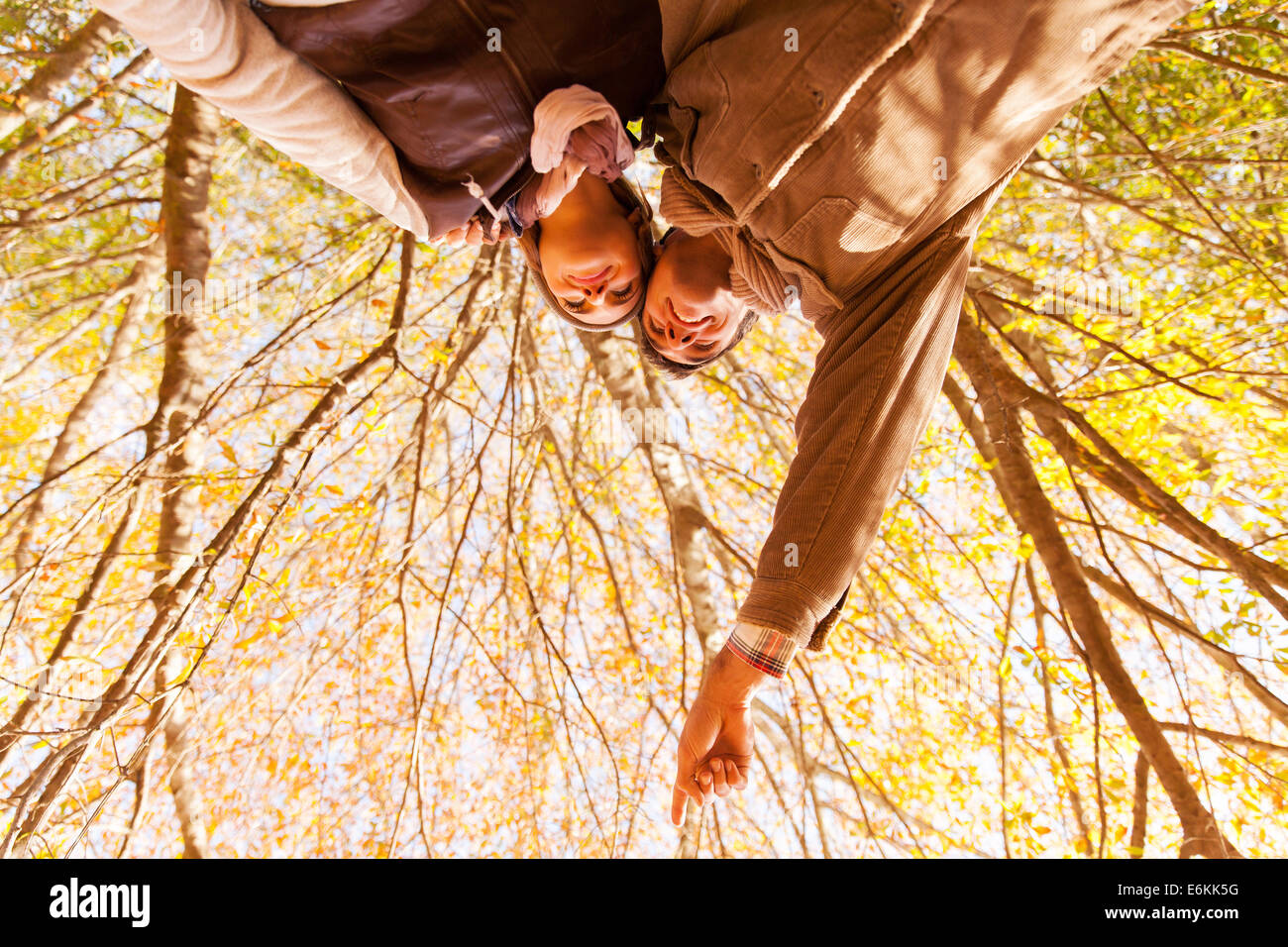 low angle view of young couple pointing in autumn forest Stock Photo ...