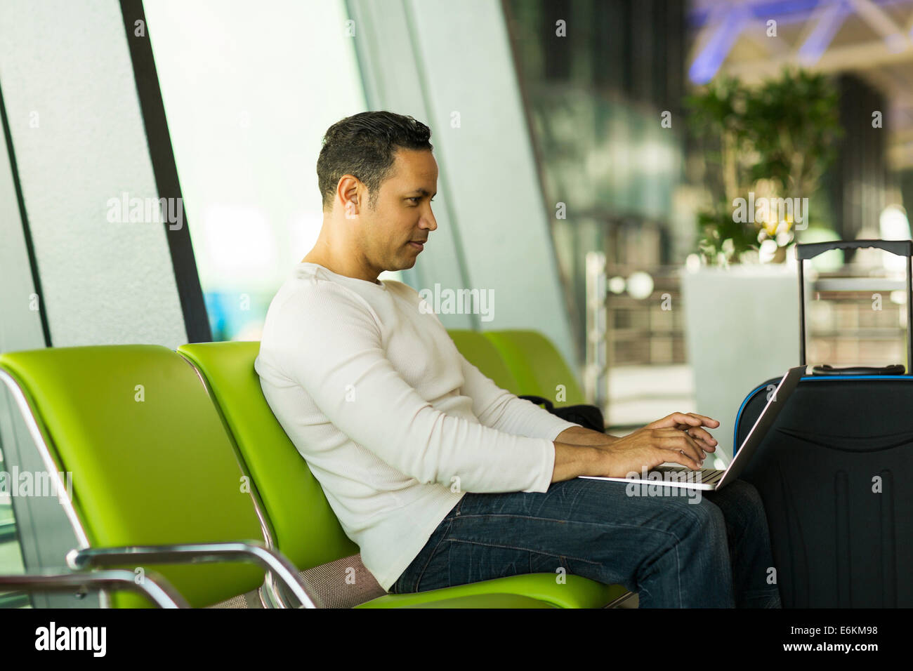 handsome man using laptop computer at airport Stock Photo - Alamy