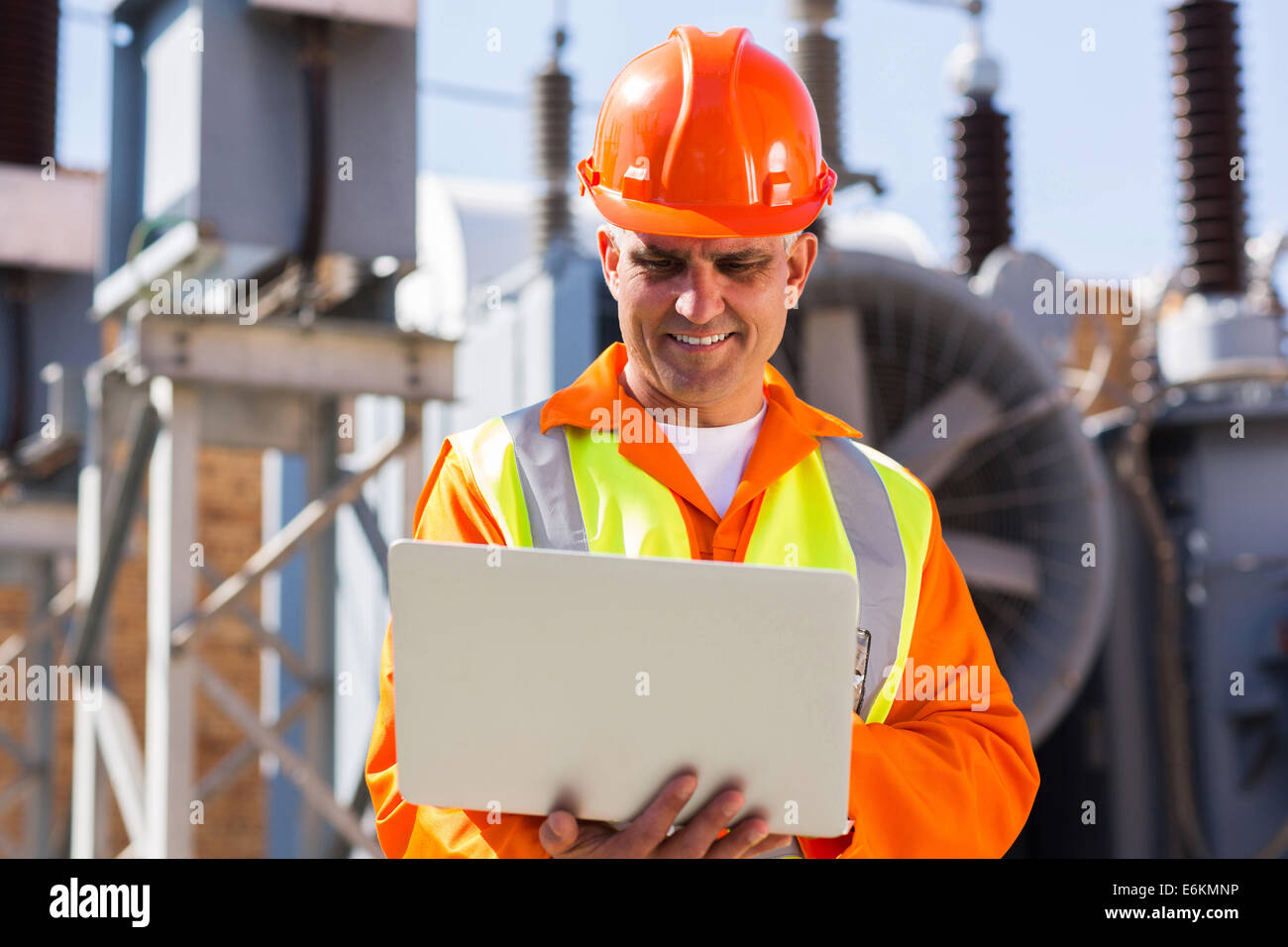 mid age engineer using laptop computer in electricity power plant Stock ...