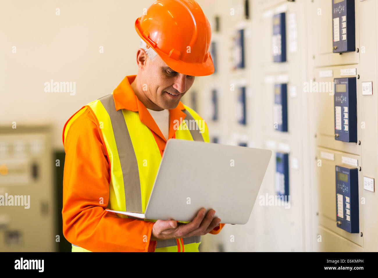 professional senior control room engineer using laptop Stock Photo - Alamy