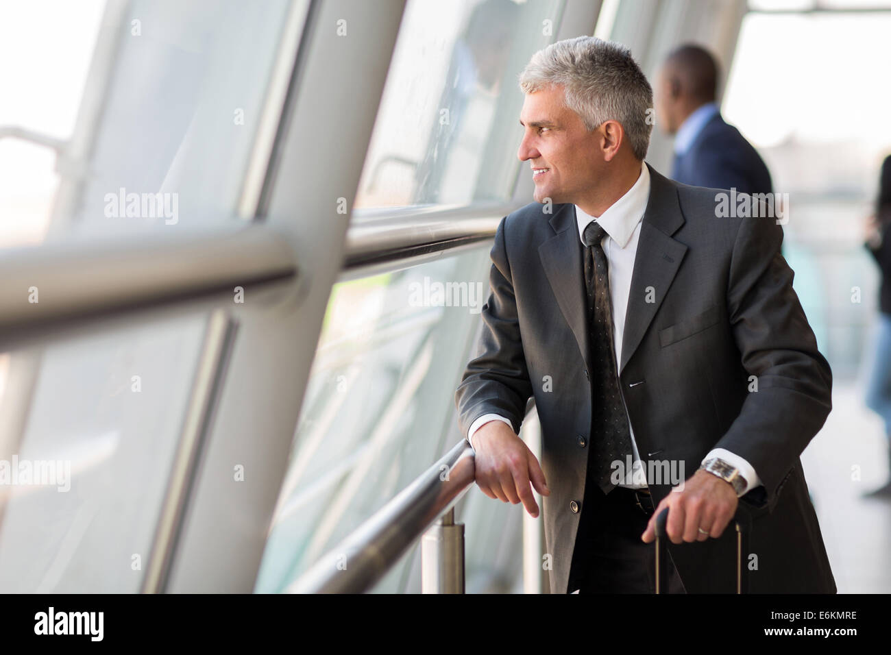 thoughtful senior business traveler at airport Stock Photo - Alamy