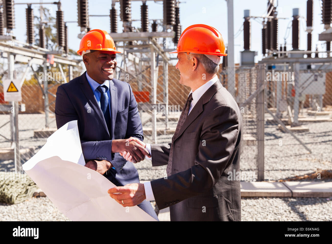 friendly business partners handshaking in electrical substation Stock ...