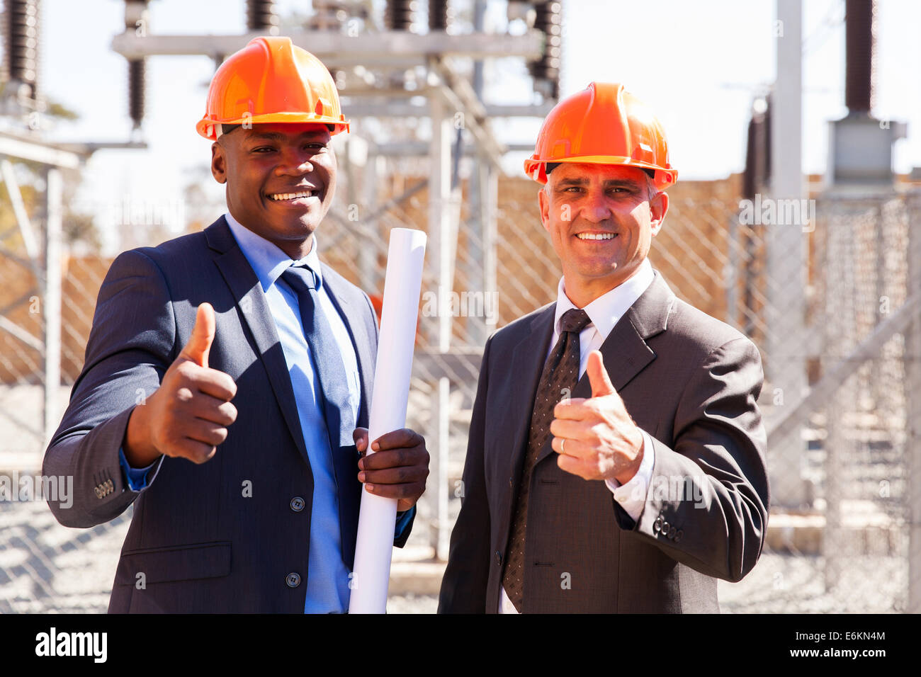 portrait of electrical inspectors giving thumbs up at substation Stock ...