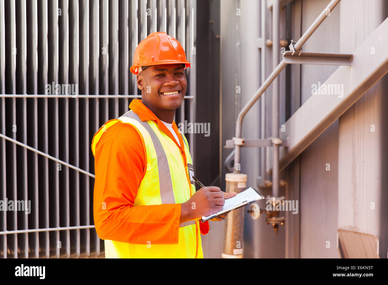 male African electrical worker in front of transformer Stock Photo - Alamy