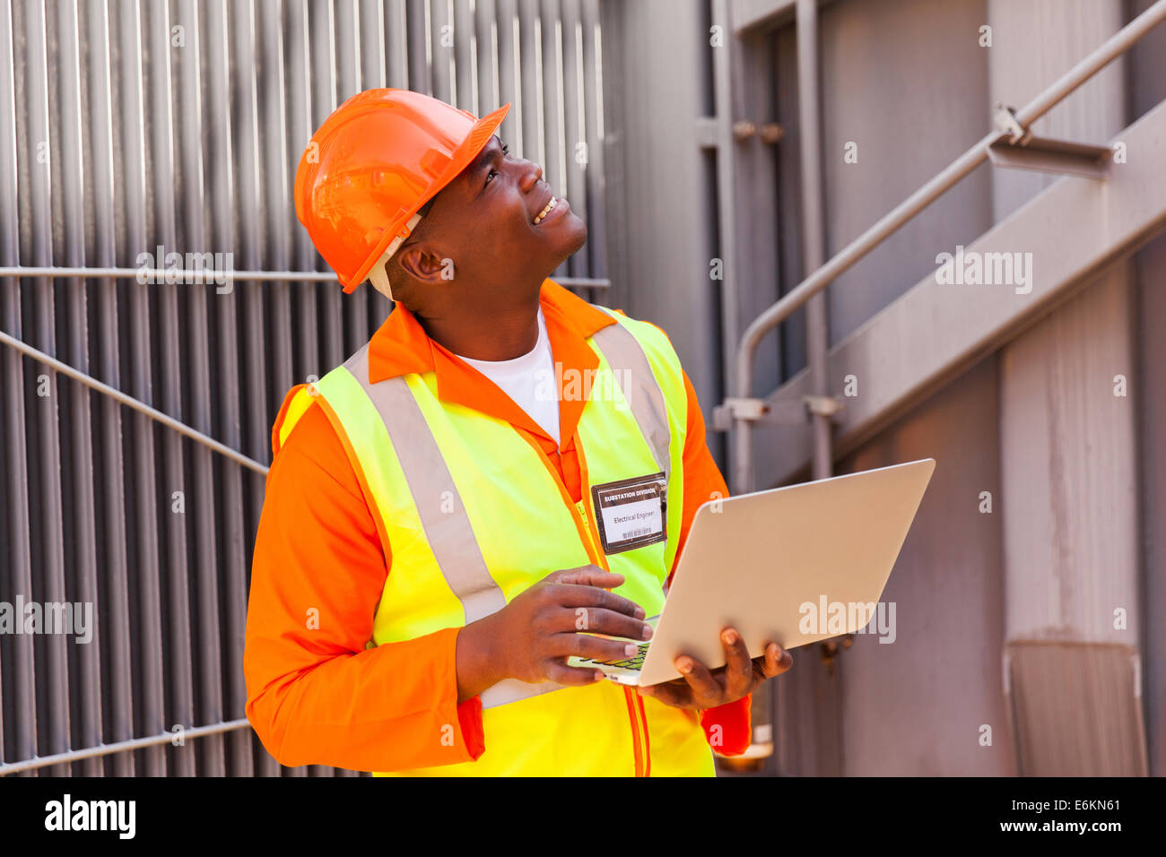 African electrical engineer using laptop in substation Stock Photo - Alamy