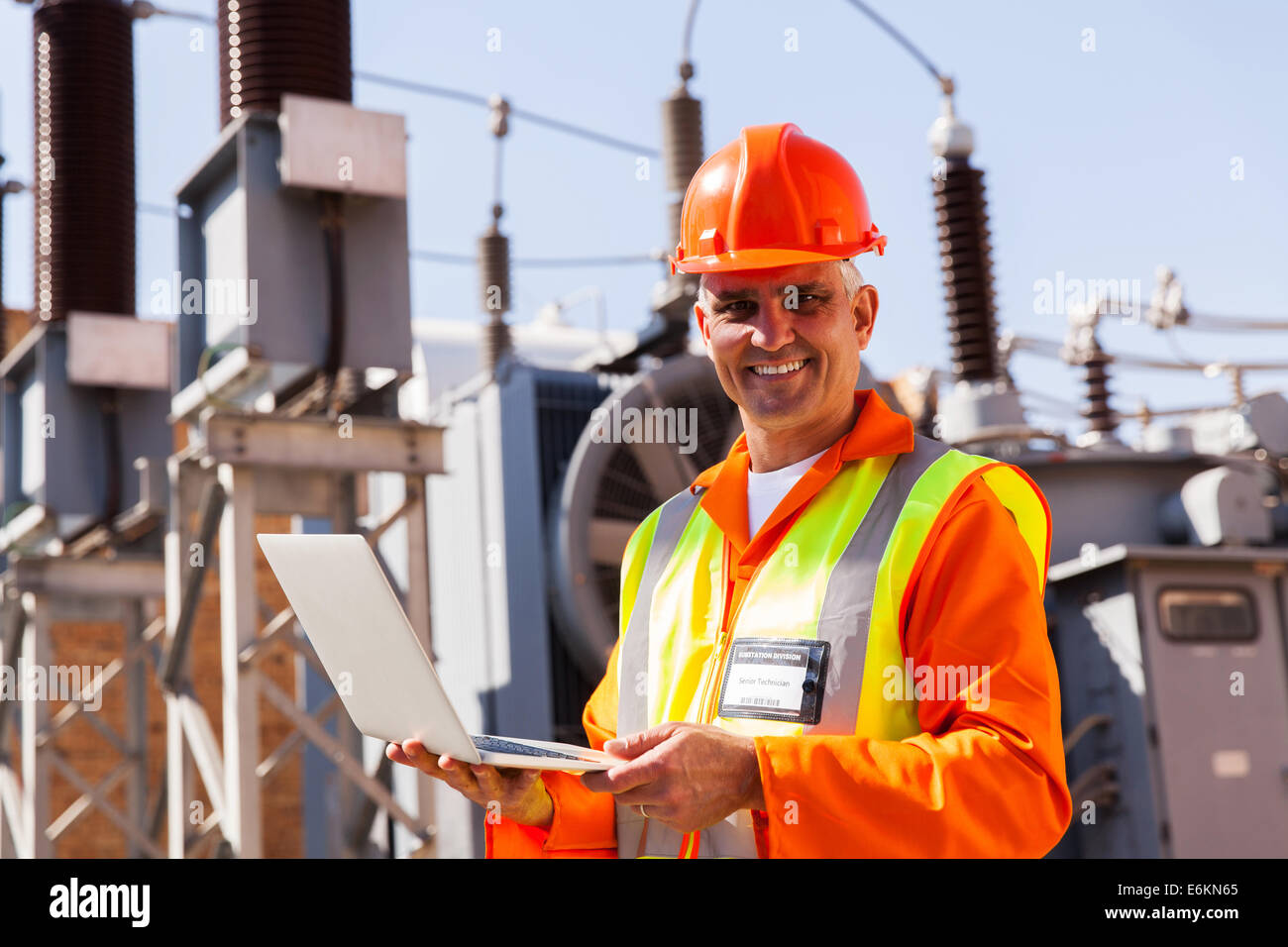 portrait of mid age technical engineer with laptop in power plant Stock ...