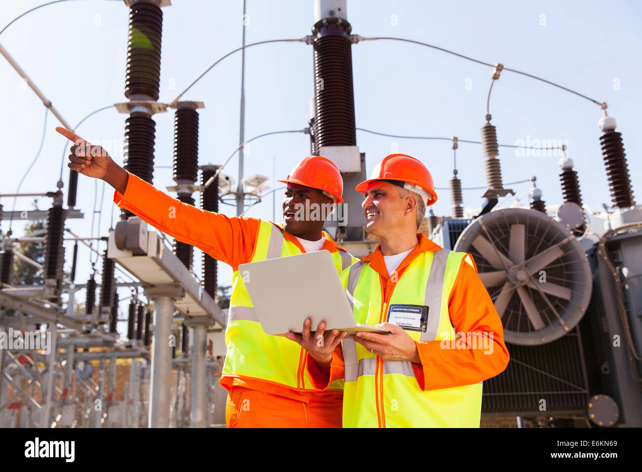 senior technician with co-worker working together in power plant Stock ...
