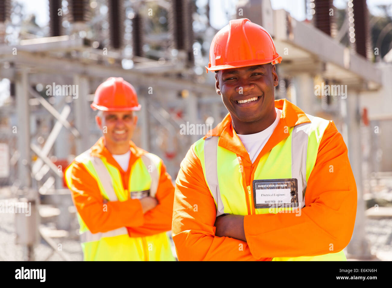 handsome young African American electrical engineer with arms crossed ...