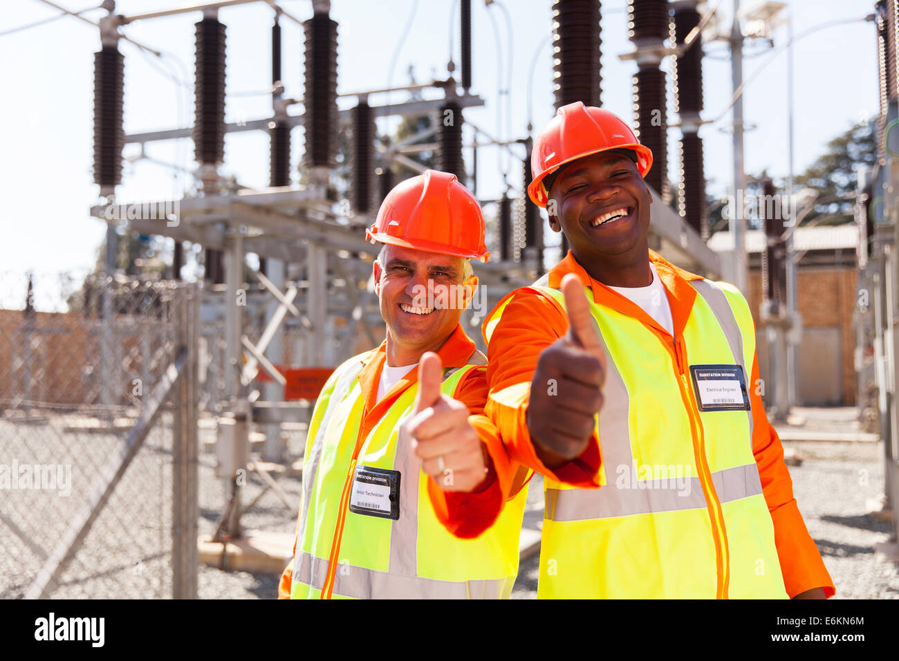 two cheerful technicians giving thumbs up in substation Stock Photo - Alamy