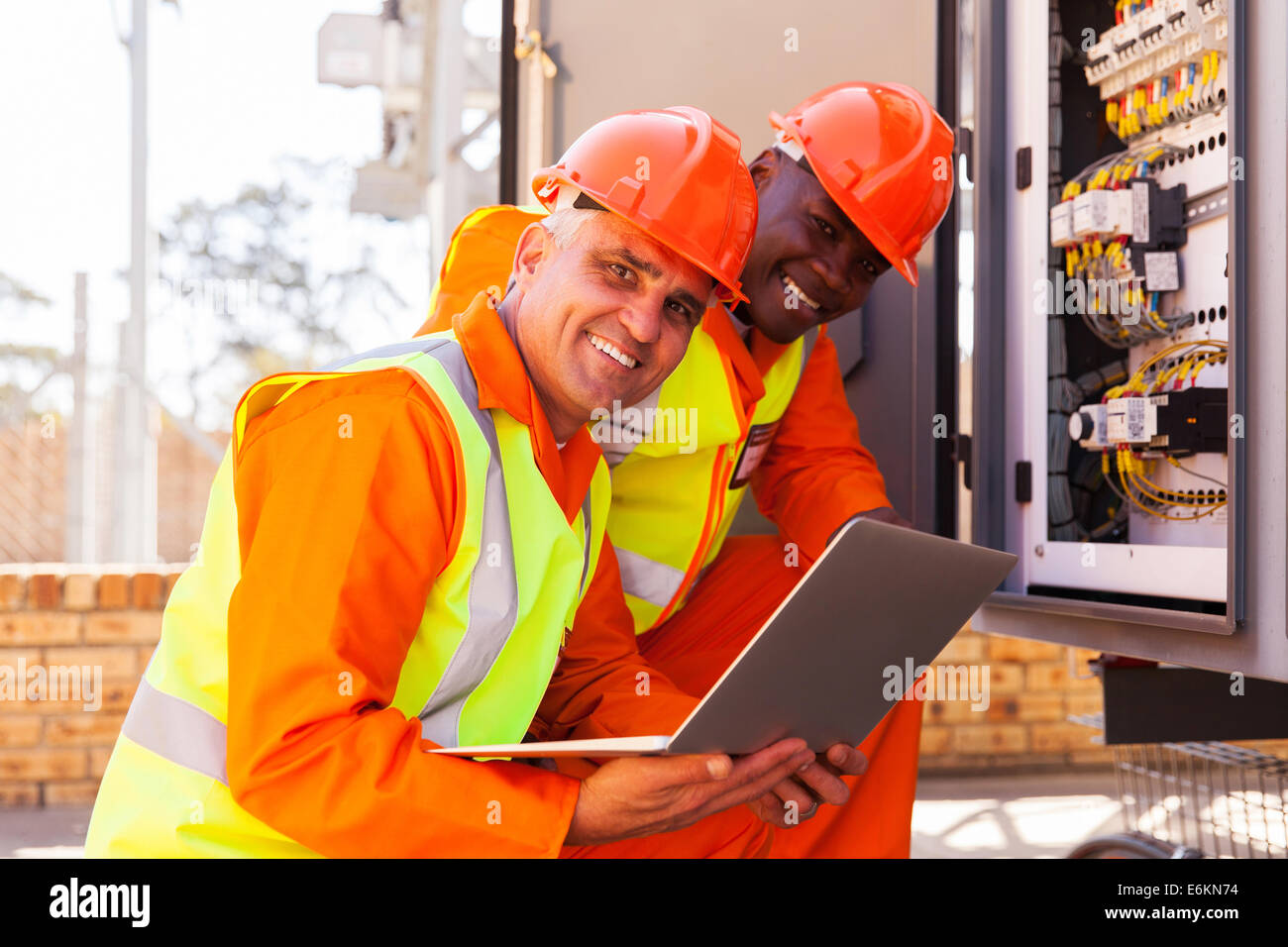 happy senior electrical engineer with co-worker in substation Stock ...